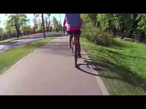 Slim black pantyhose and pink sweater on a girl with city bike.