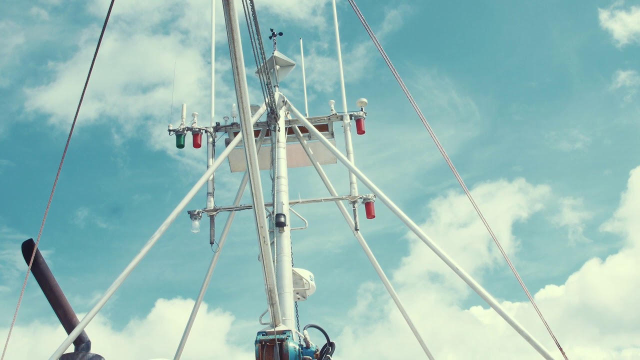 the mast of a large fishing boat in the ocean - YouTube