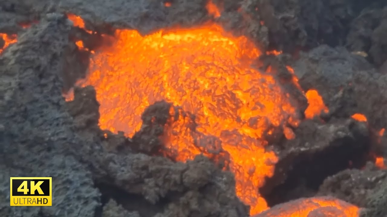 Lava spilling: People throw rocks on hot lava, common scene at the ...