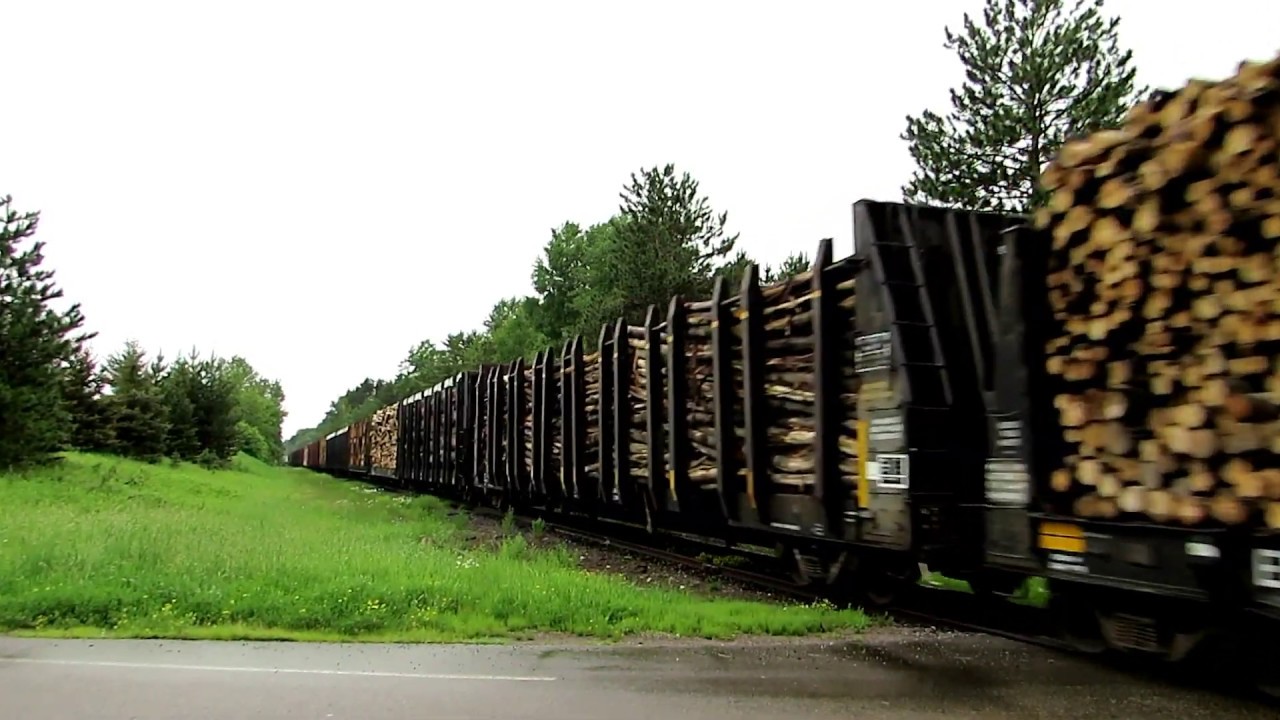 LONG TRAIN OF LOGS MOVING FAST PAST RURAL CROSSING! | Jason Asselin ...