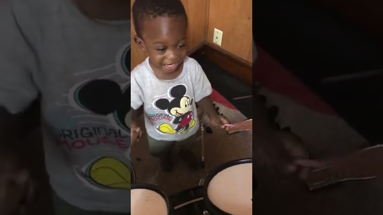 2 year old plays on drums & sings a song in creole - YouTube