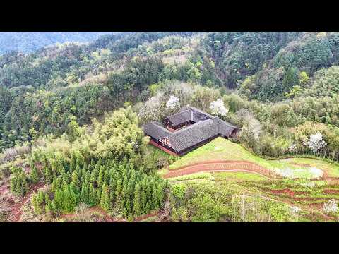 Eine Familie in Sichuan lebt in einem Hofhaus, das von Wäldern umgeben ist.