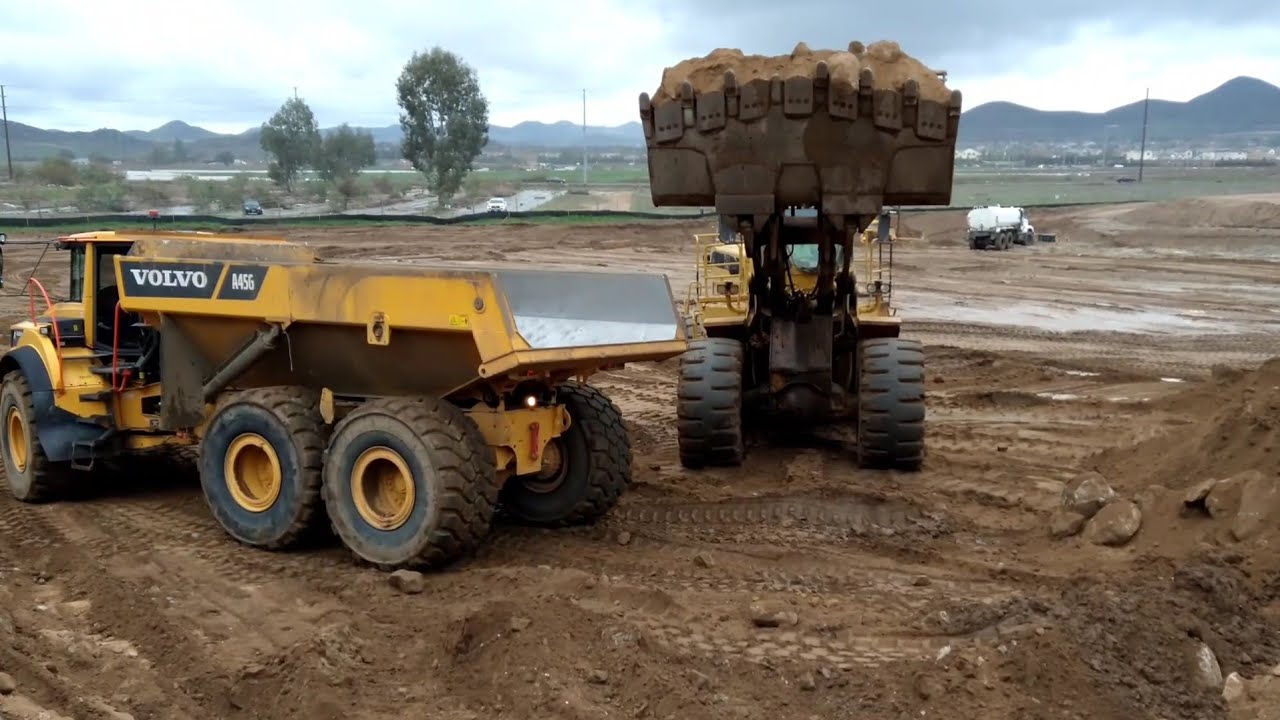 CAT 988F wheel loader loading Volvo A45G articulated haulers - YouTube