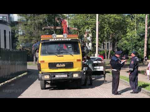 Traffic officers moving car with wrecker