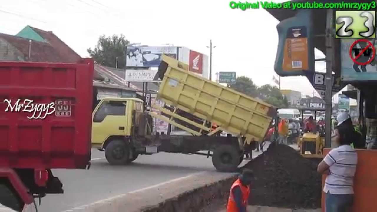 Dump Trucks Dumping Aggregate Rock On Busy Road In Indonesia - YouTube