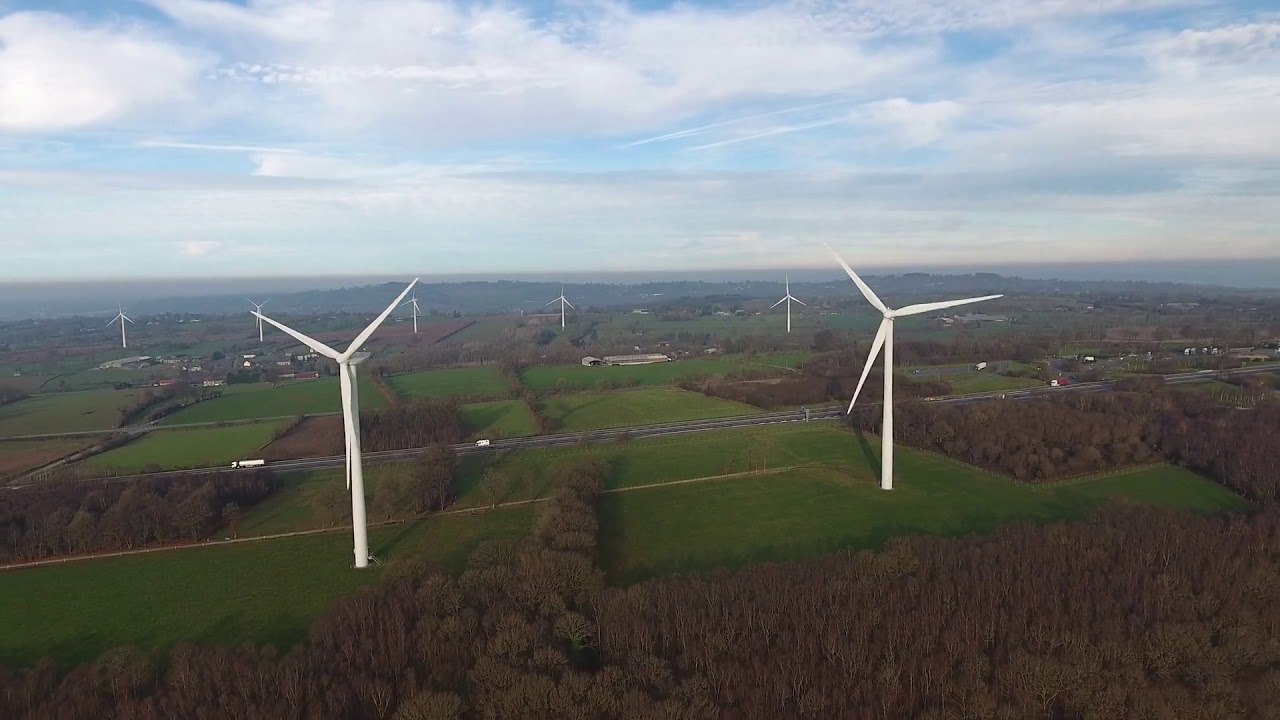 wind turbines along a highway and fields in normandy france drone a ...