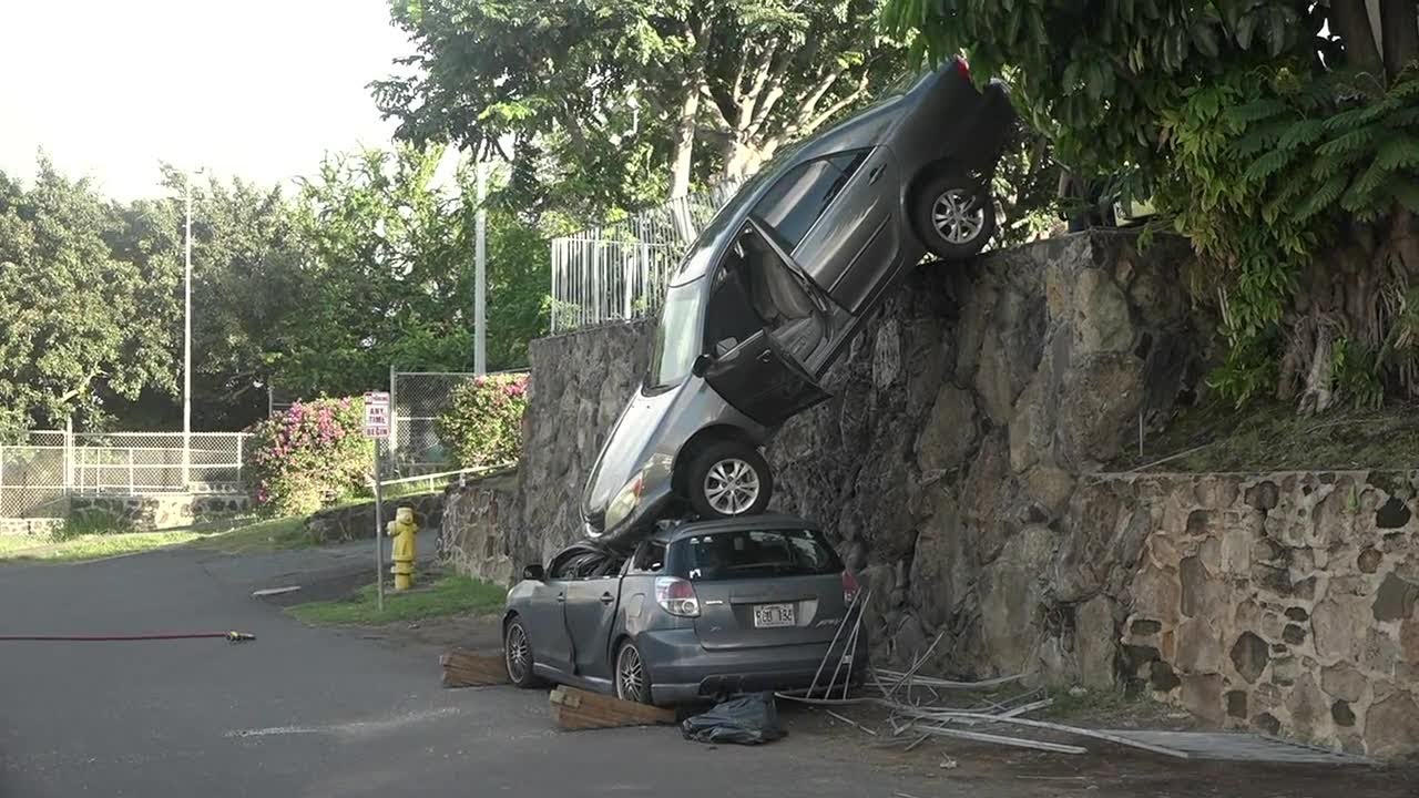 Car goes over cliff, lands on parked car Punchbowl area - YouTube