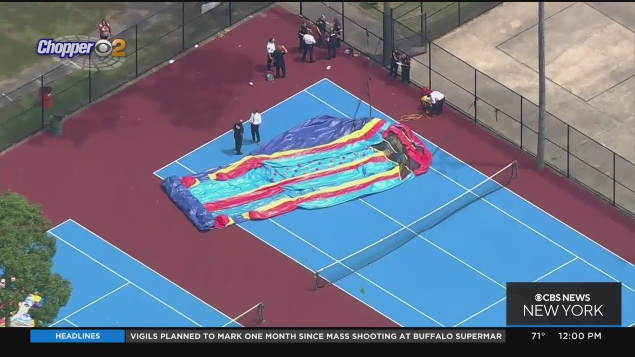 Students hurt when blow up slide collapses during field day - YouTube