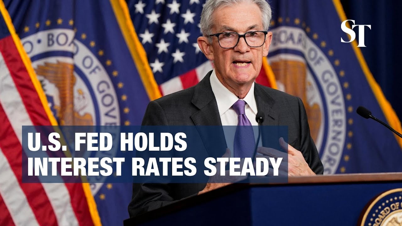 US Fed holds interest rates steady, but signals cuts ahead - YouTube