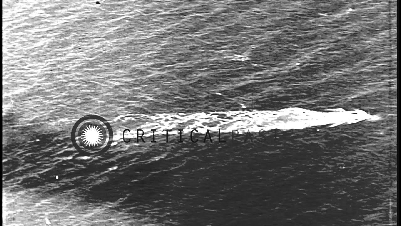 Aerial view of a US submarine underwater and leaving trails in the ...