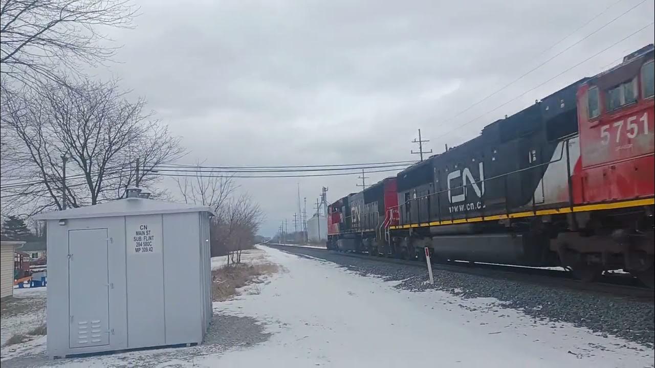 CN 5775 and 5751 hauling misculanious rail cars eastbound - YouTube