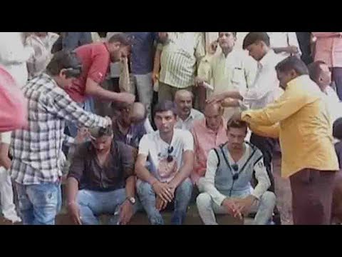 Men tonsure heads in protest of cow slaughter in Kerala - YouTube