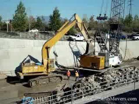 CAT 245D performing an unusual task - YouTube