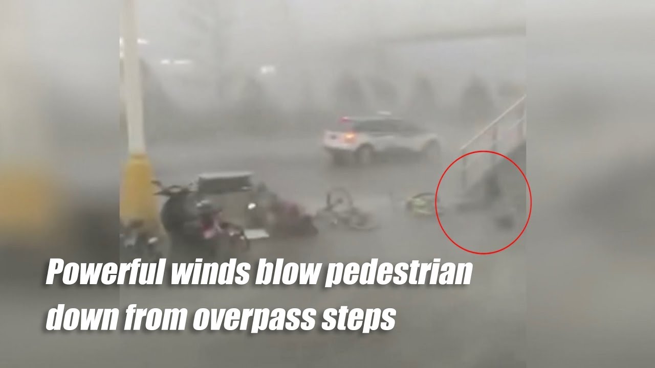 Powerful winds blow pedestrian down overpass steps - YouTube