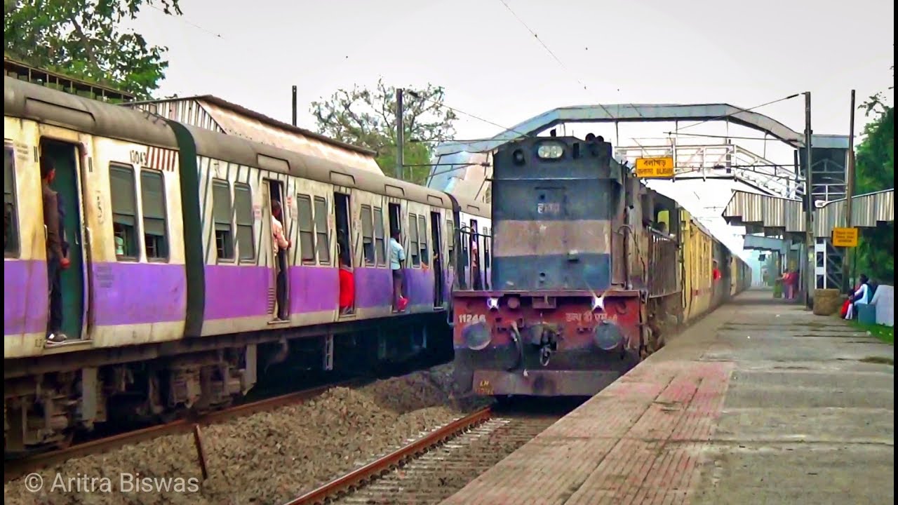 Rusty Diesel locomotive hauling Intercity Express train crossing purple ...