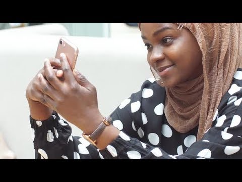 Young Muslim Woman Holding a Smartphone and Looking at Camera | Stock Footage - Videohive
