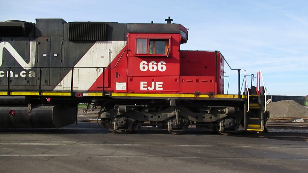 CN SD38-2 pulls local freight train through new grade crossing at ...