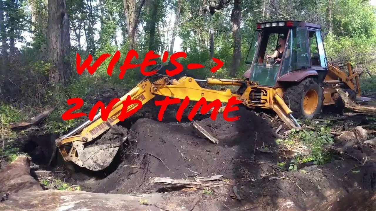 Wife runs backhoe for the second time - YouTube