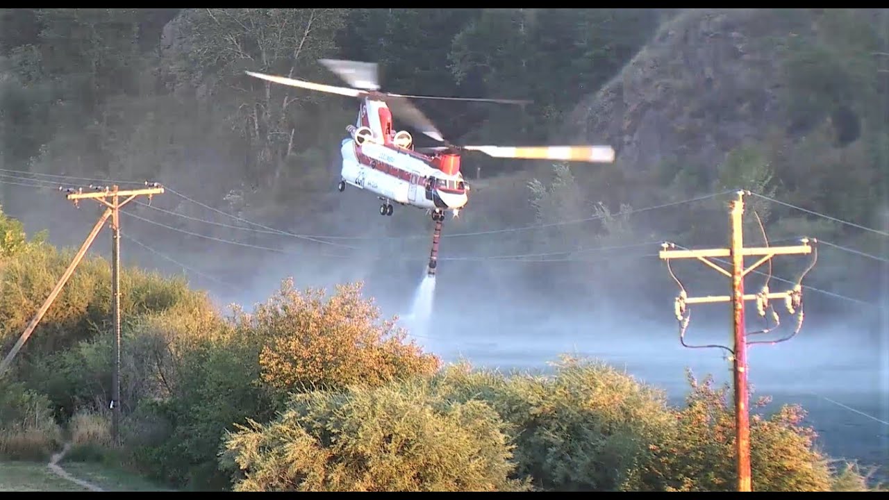 Helicopter collecting water for the fire on Mt Sentinel, Missoula ...