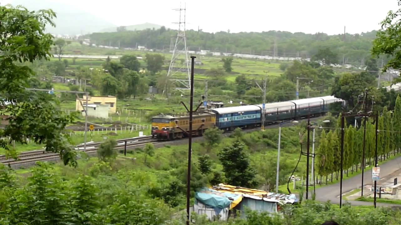 Pulsar 200NS watches as 11009 Mumbai-Pune Sinhagad Express negotiates ...