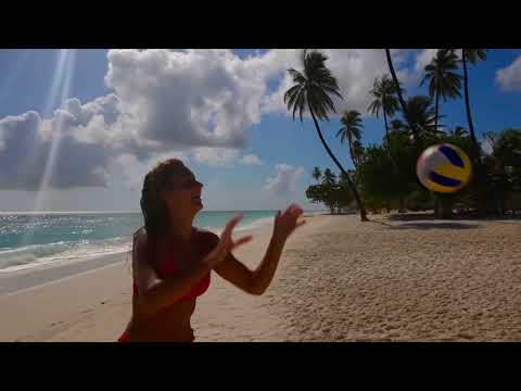 A Woman in a Red Bikini Playing Volleyball on a Beach