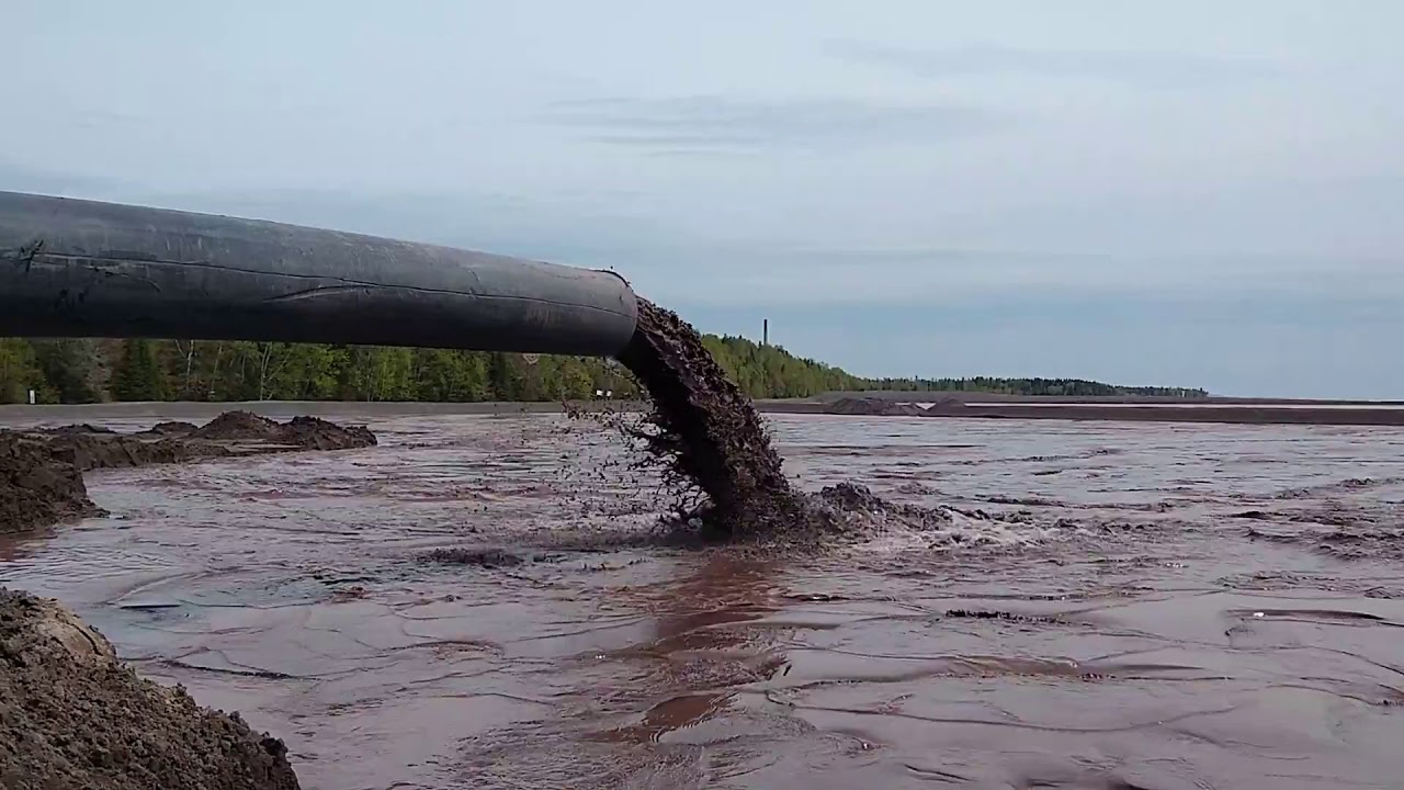 Dredged stamp sands are deposited on the shore. - YouTube