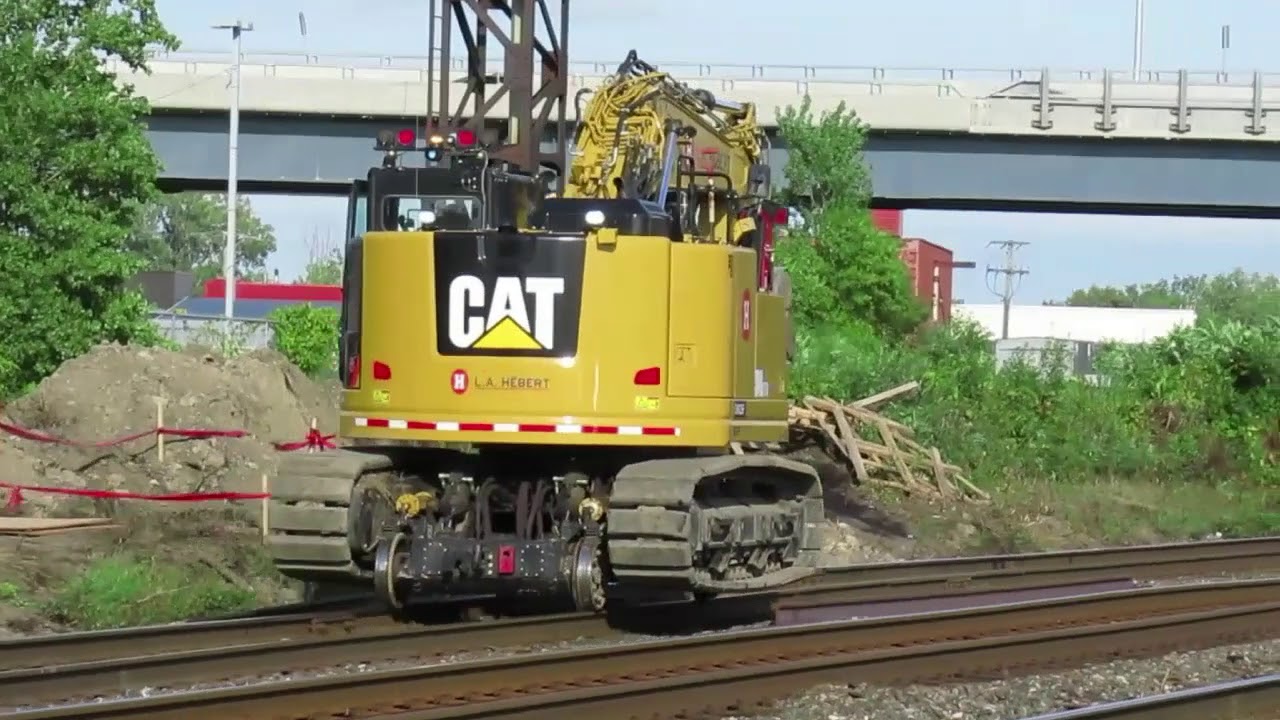 CAT DIGGER WITH HI-RAIL MOVING ALONG CN LINE IN MONTREAL - 9-11-19 ...
