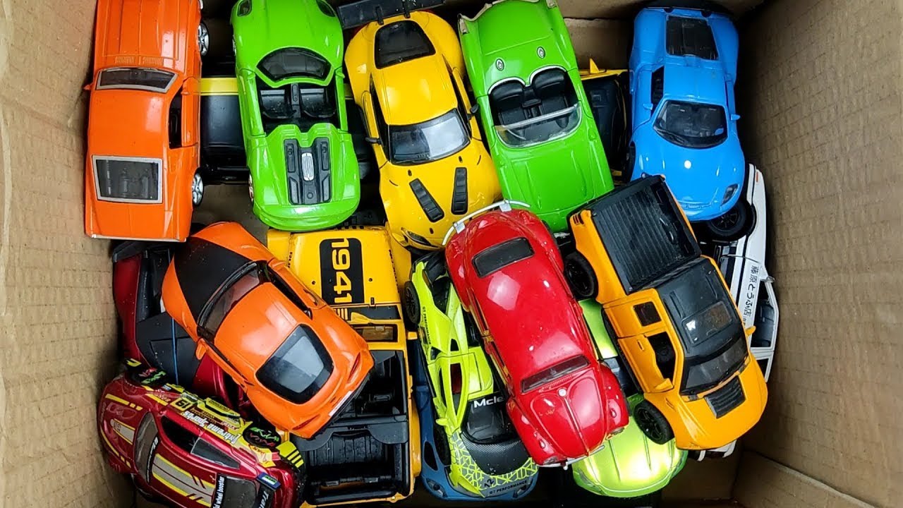 Box full of various miniature cars Peugeot, Jaguar, Pagani, Hyundai ...