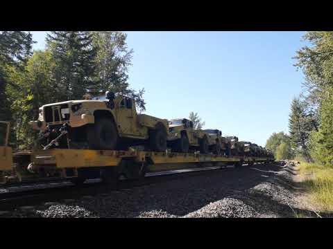 BNSF #8462 with New Military vehicles. Looks like the Hummer Replacement defect detector on ...
