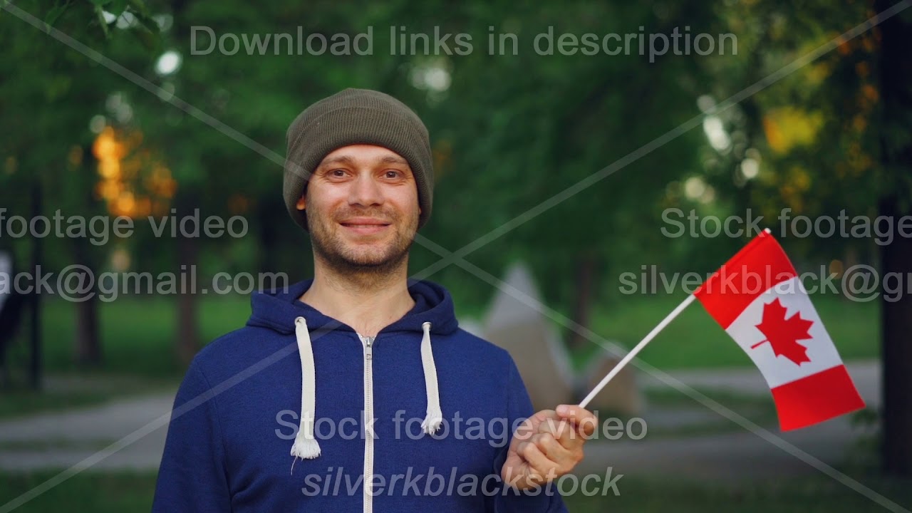 Slow motion portrait of Canadian sports fan waving official flag of ...