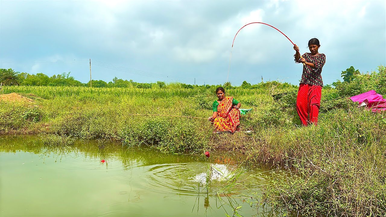 Fishing Video | Two women are fishing from a small pond next to the ...