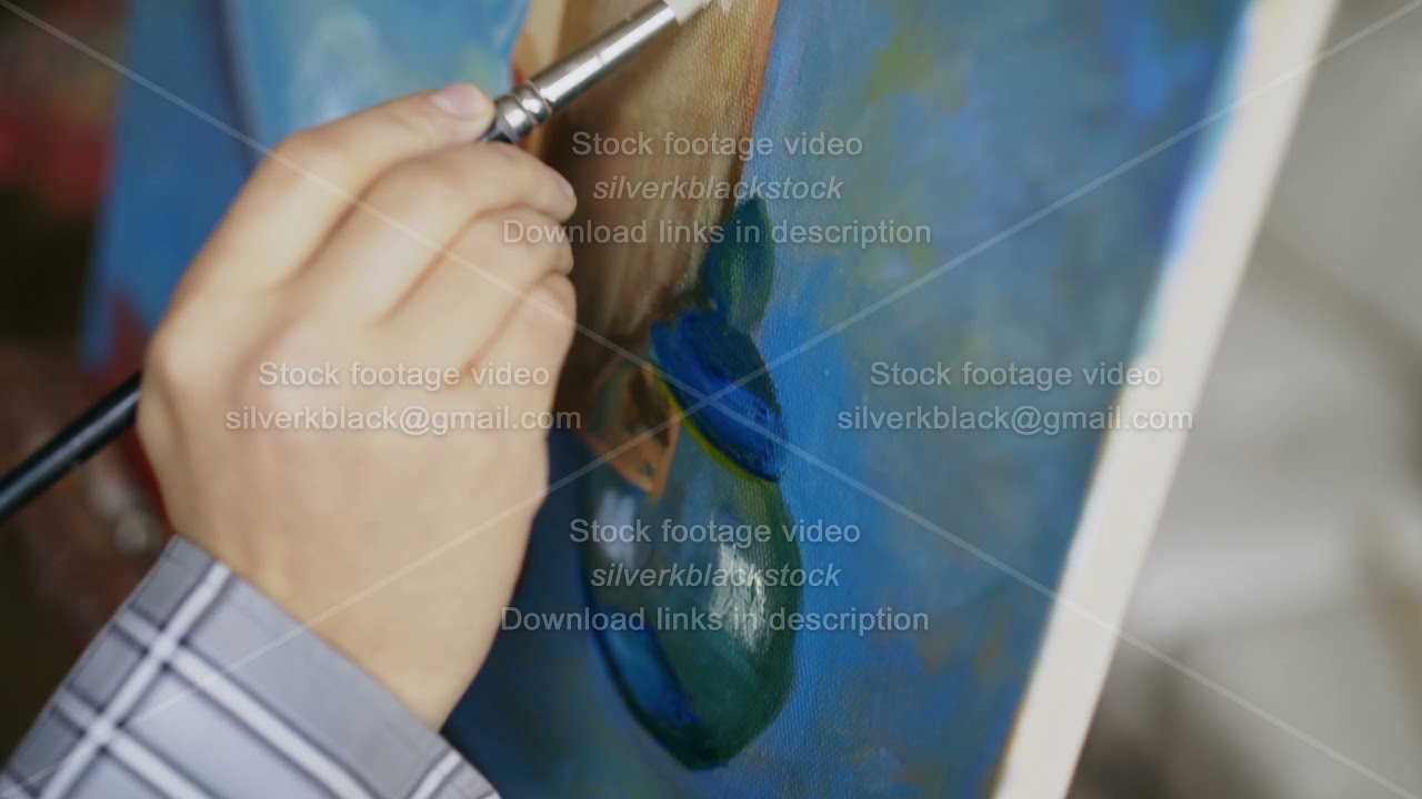 Close up of man's hand painting still life picture on canvas in art ...