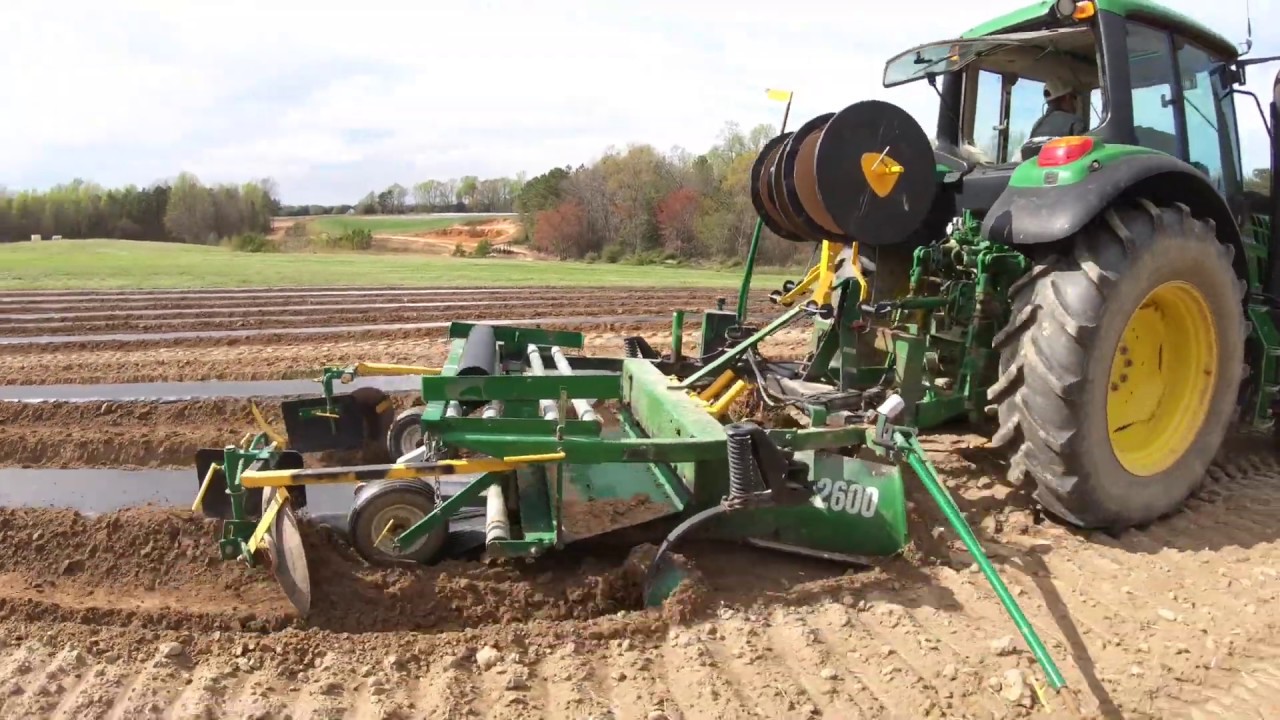 Laying plastic mulch with a John Deere 6115m and a Rainflo Irrigation ...