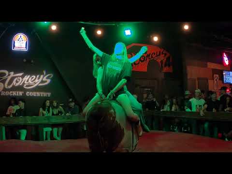 Mechanical bull riding in Las Vegas: Two friends hang on until one hangs off