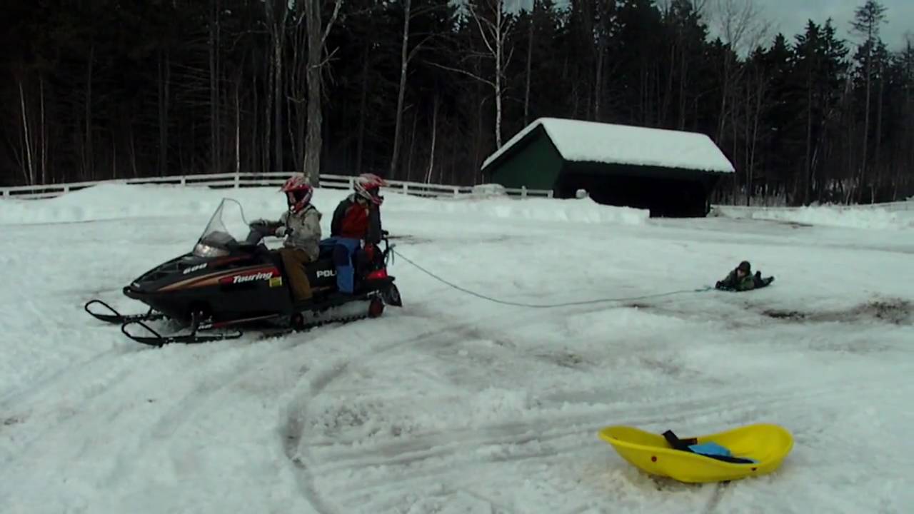 boys tow little brother behind snowmobile - YouTube