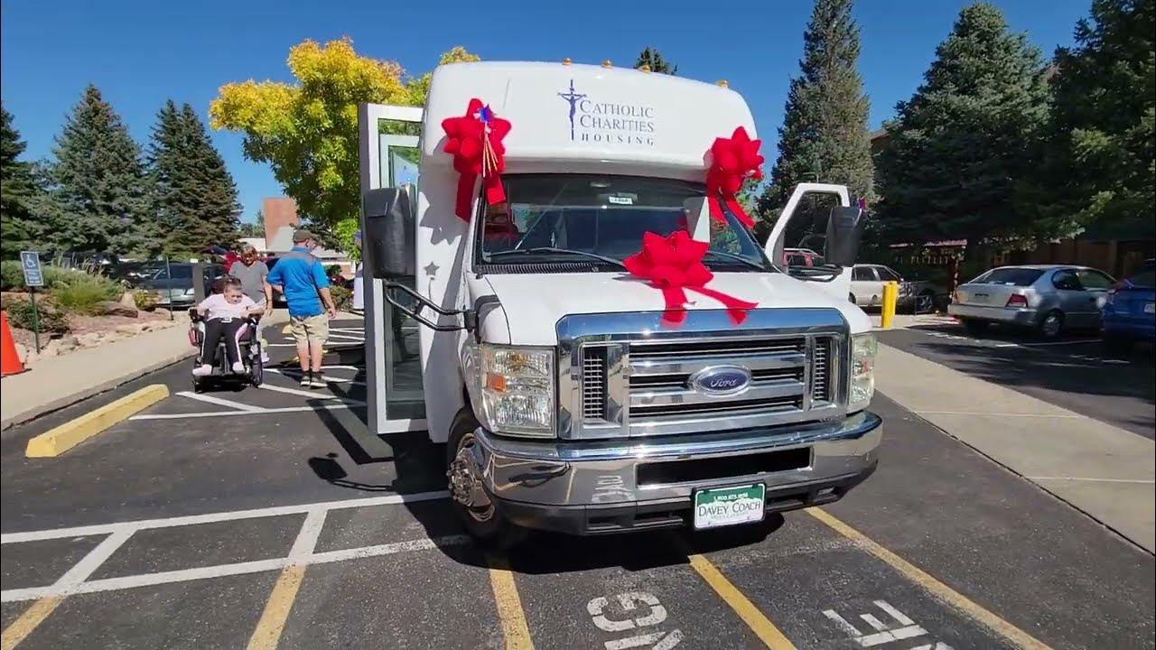 Surprise Bus Delivery for Catholic Charities Housing - YouTube