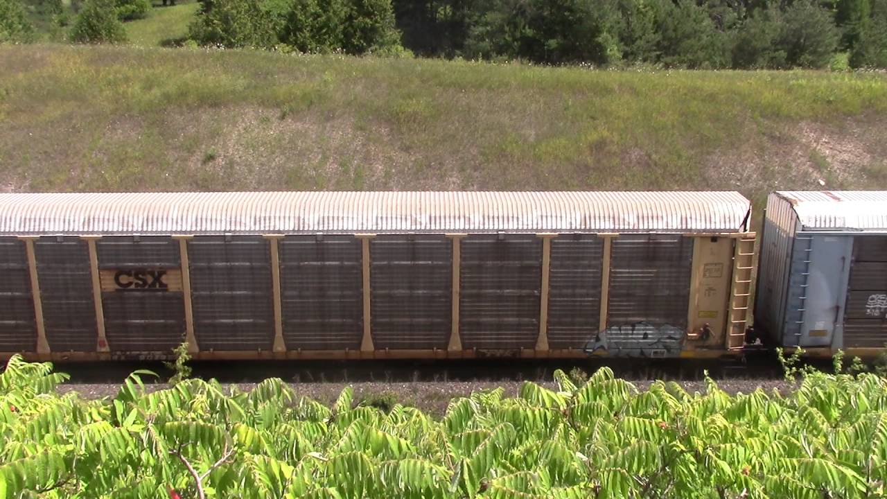 CN X371 FEMA(Autorack) train with a centre beam flatcar at the end at ...