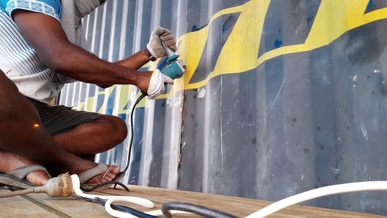 Cutting a shipping container with angle grinder - YouTube
