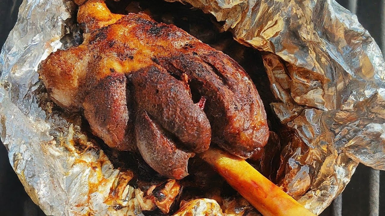 Lamb Shank wrapped in Aluminum foil paper and roasted on charcoal Grill ...