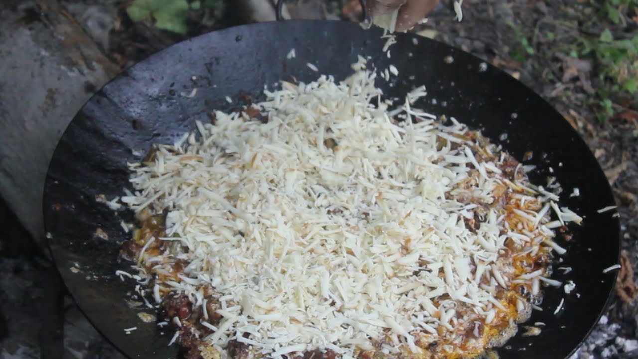 Meat dish with cheese over hot fire - YouTube