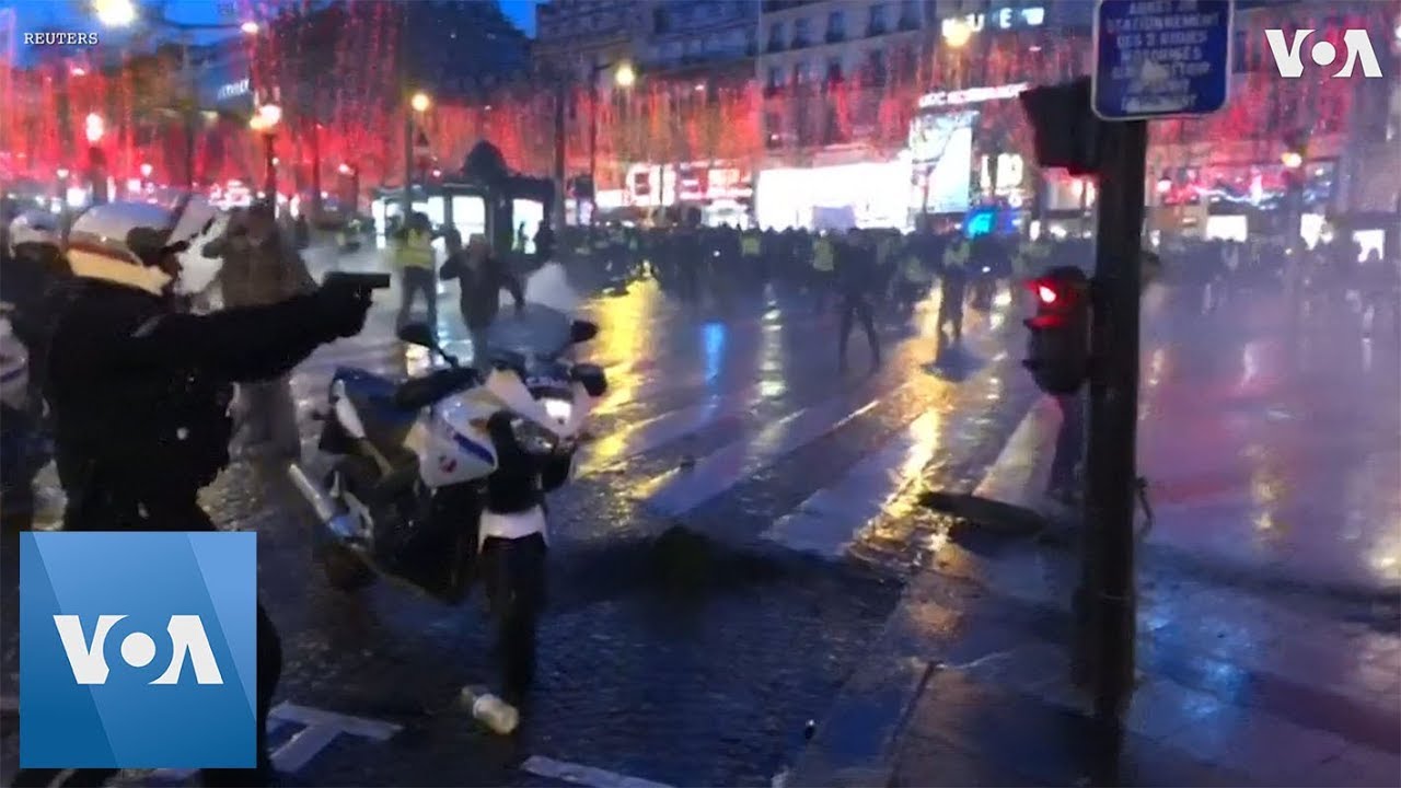 French Policeman Pulls Gun On Protesters on Champs Elysees - YouTube