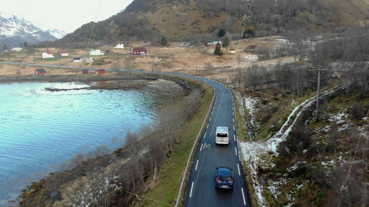 aerial fly over tilted shot with view of islands and coastal road in ...