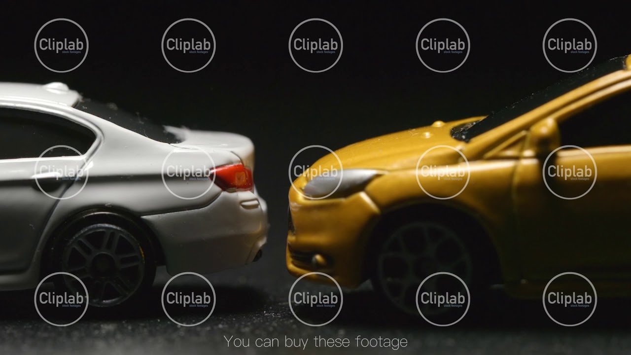 ACCIDENT: Close up of toy model car crashes to white toy car (slow ...