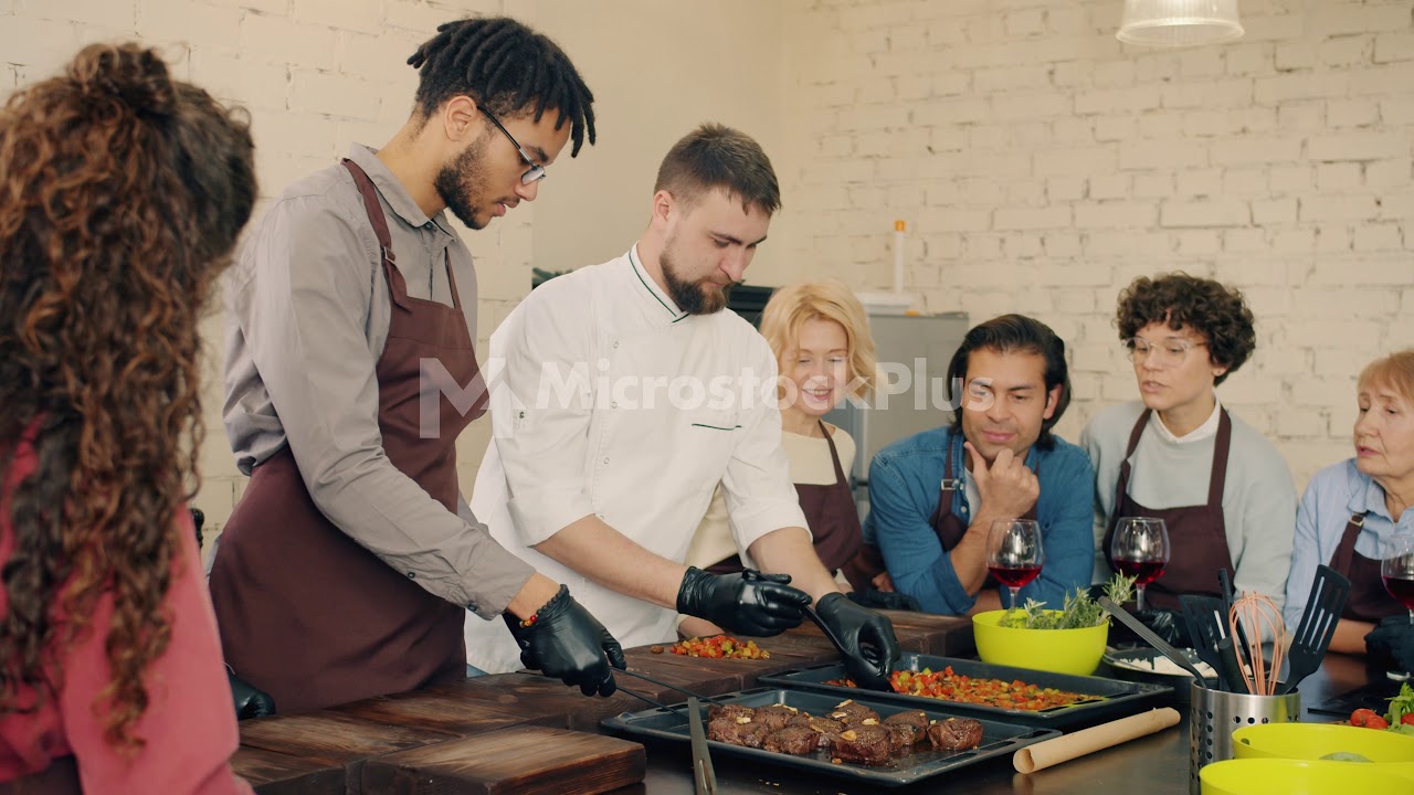 Slow motion of cook serving cooked meals on wooden boards teaching ...