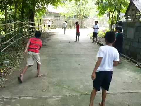 Filippino kids playing Tumbang Preso or Knock Down the Prisoner in ...