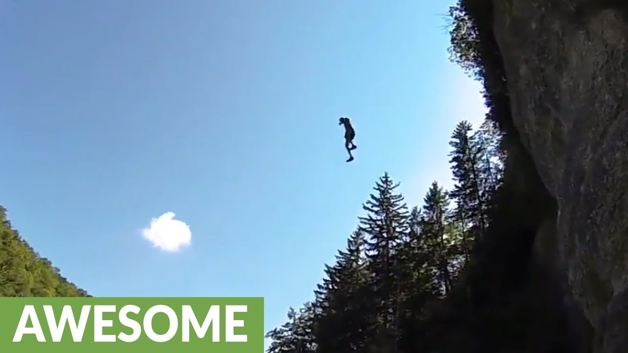 Crazy daredevil jumps off 100 ft cliff into water - YouTube