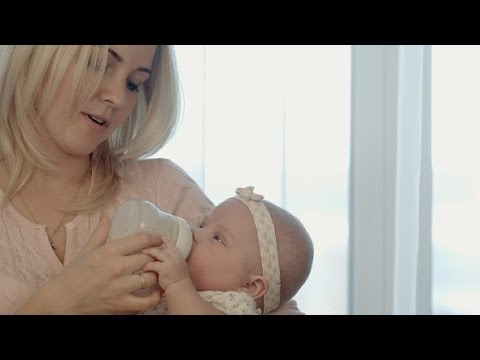 Happy Mother Feeds The Baby Bottle | Stock Footage - Videohive