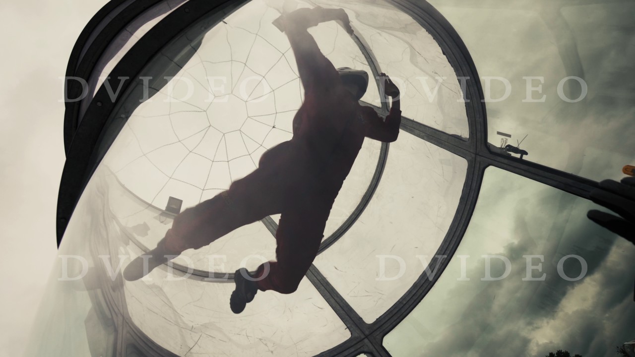 Woman flying in a wind tunnel. Indoor skydiving wind tunnel. Extreme ...