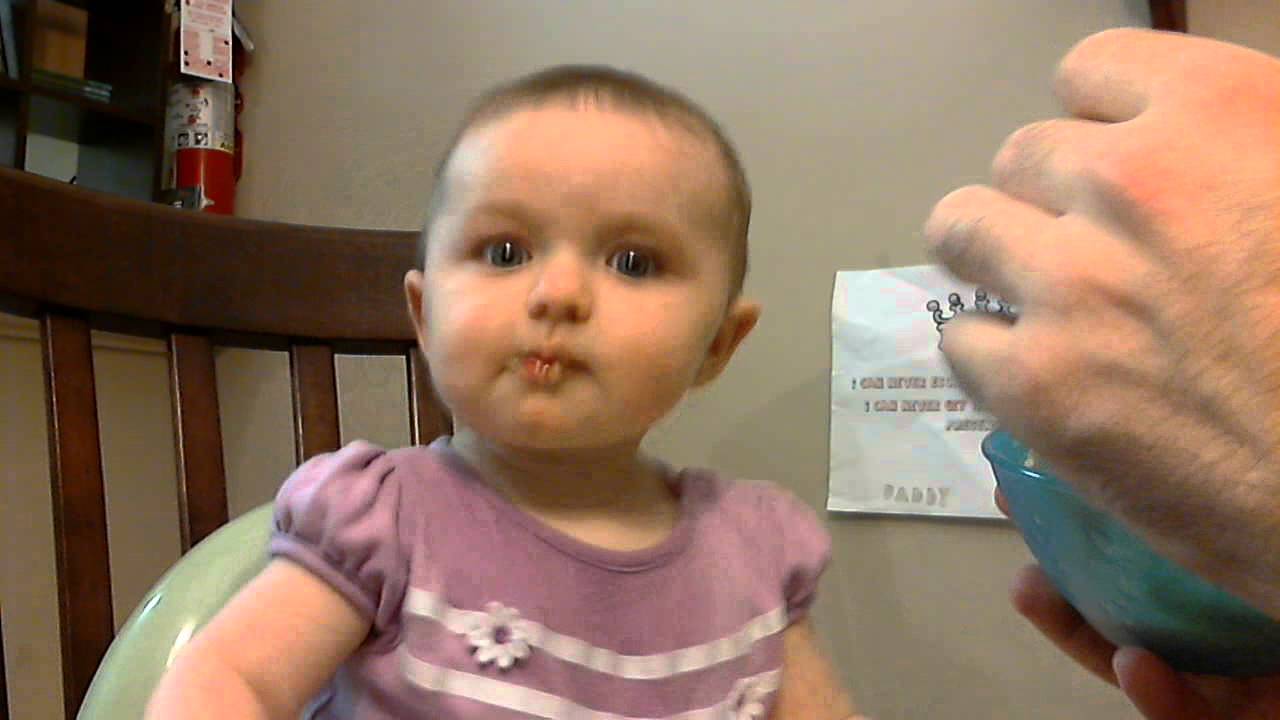 Mercy smacking her baby food - YouTube