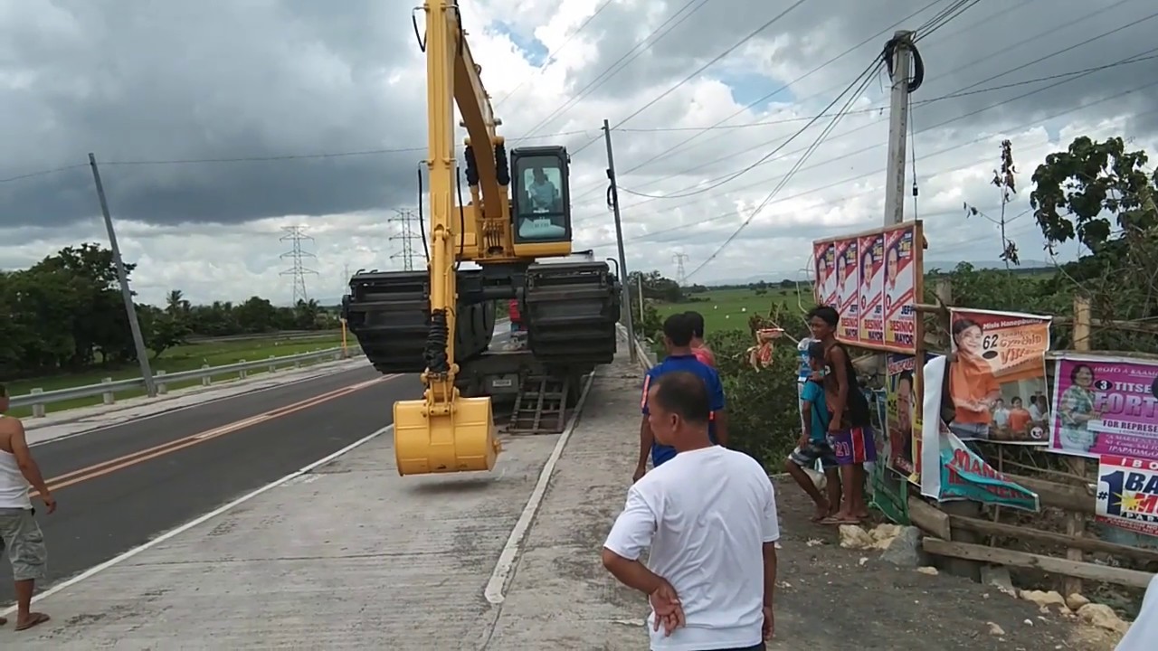 Amphibian backhoe excavator, unload in the track, over slow motion ...